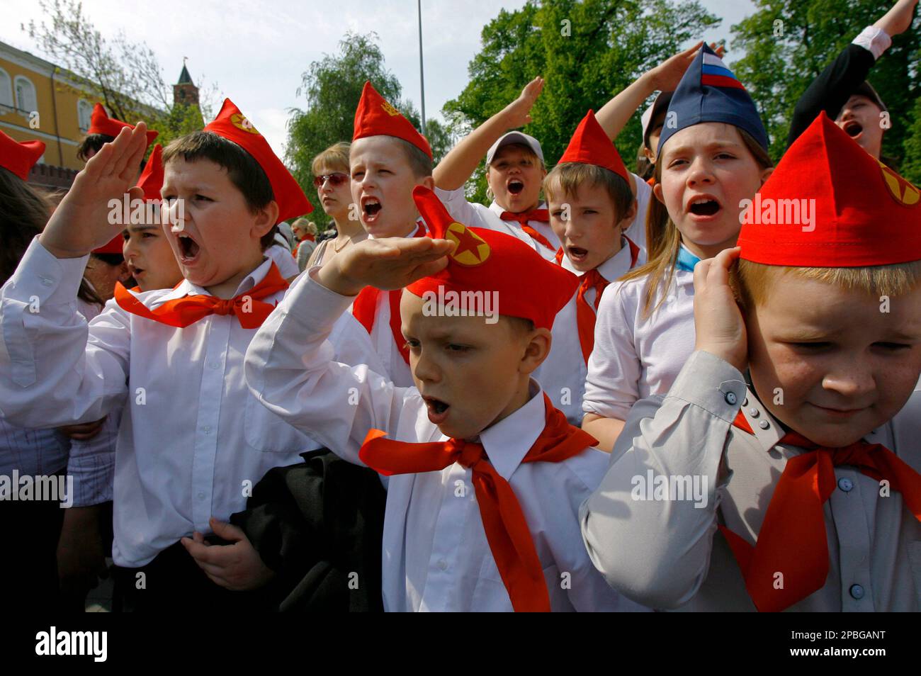 Teenagers, members of the Young Pioneers, salute during a ceremony of ...
