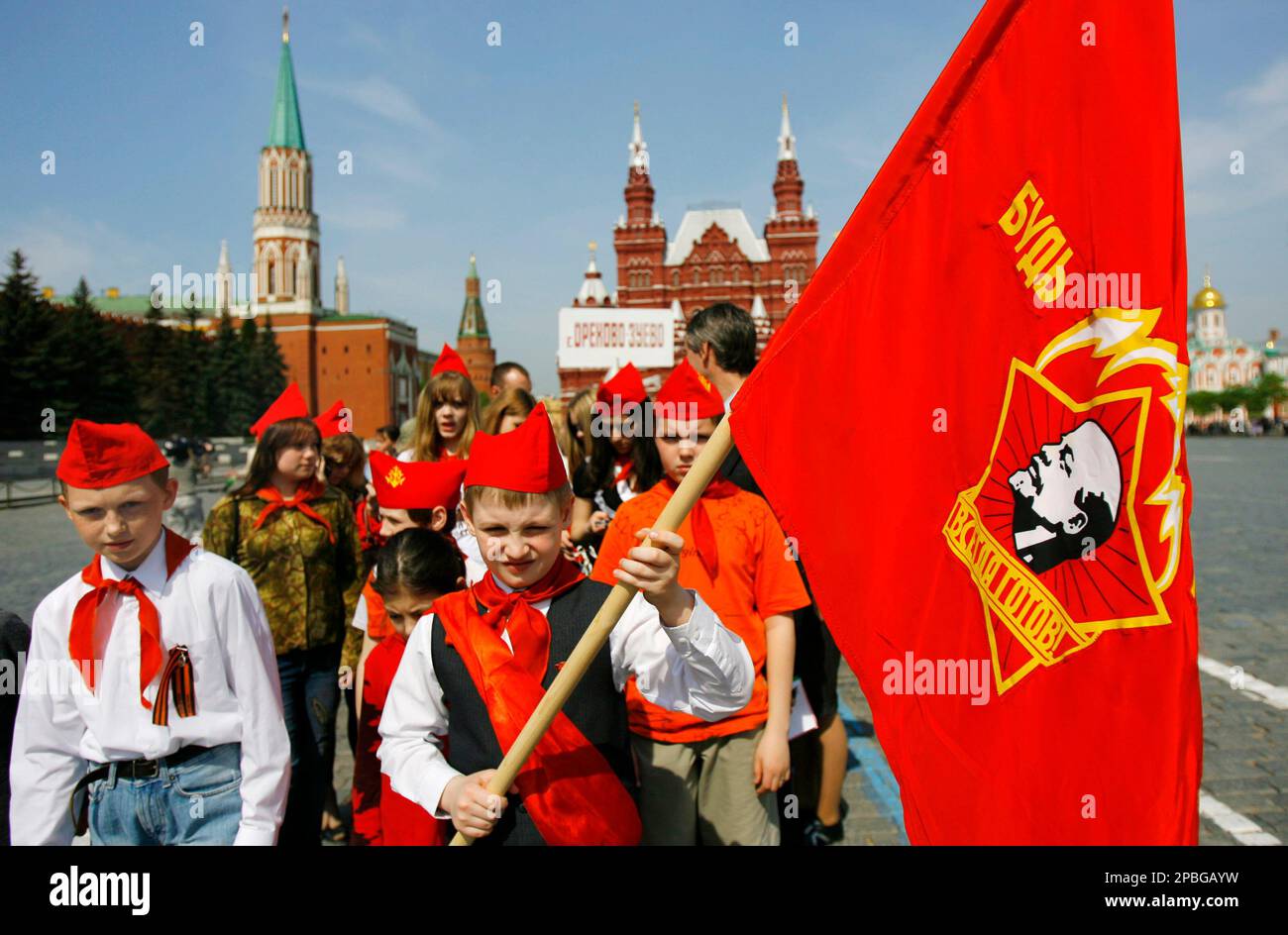 Children wearing red ties, a symbol of the Young Pioneers, march along ...