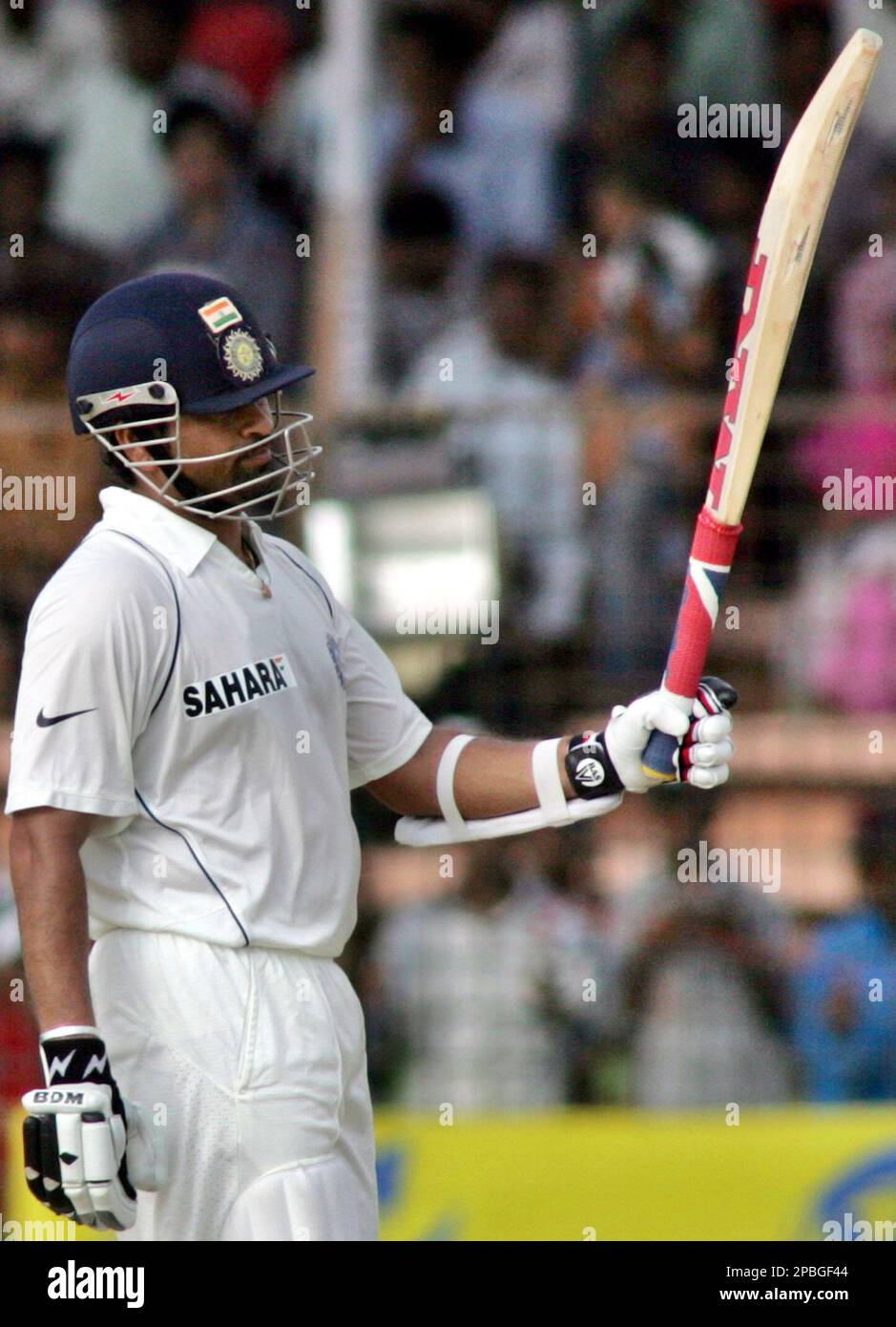 Indian cricketer Sachin Tendulkar raises his bat to acknowledge the ...