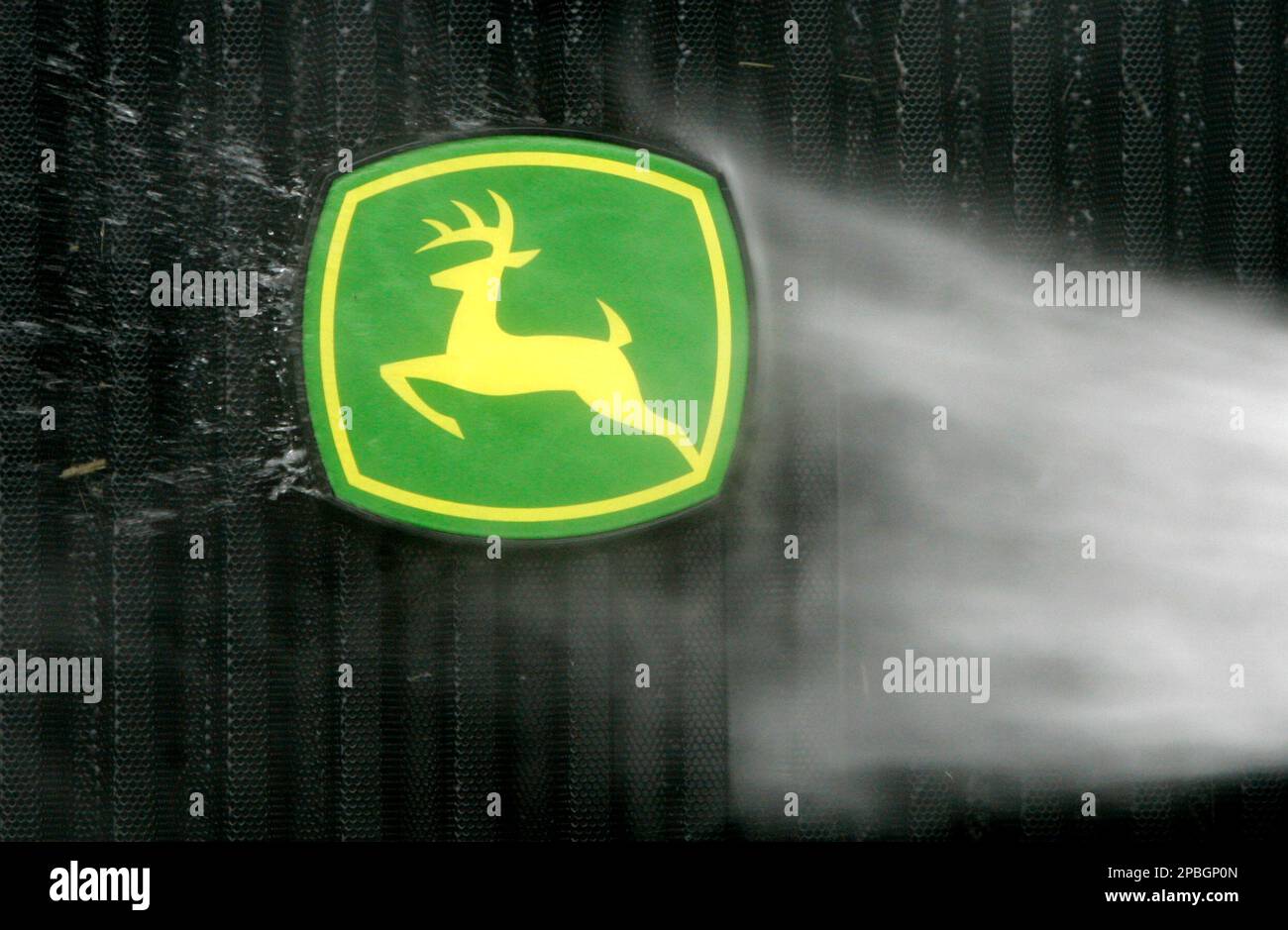 Water splashes around a John Deere logo as Zachary Herald washes a ...