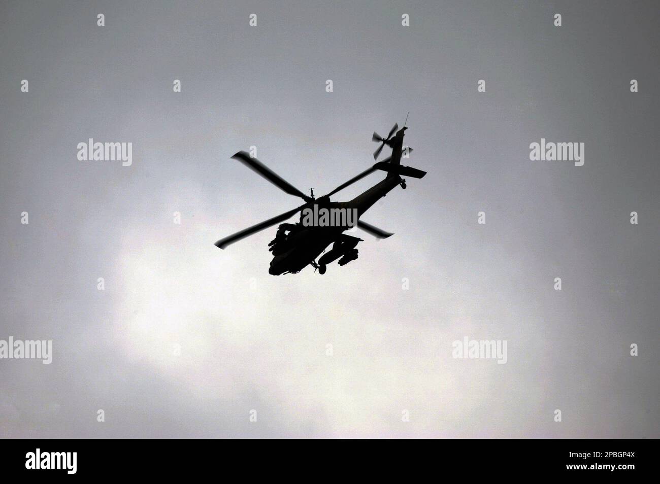 An Israeli attack helicopter flies over the town of Sderot between ...