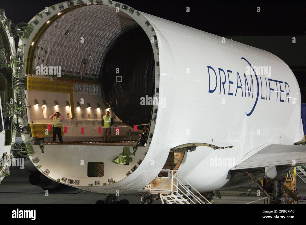 Boeing employees wait to unload the super freighter 'Dreamlifter ...