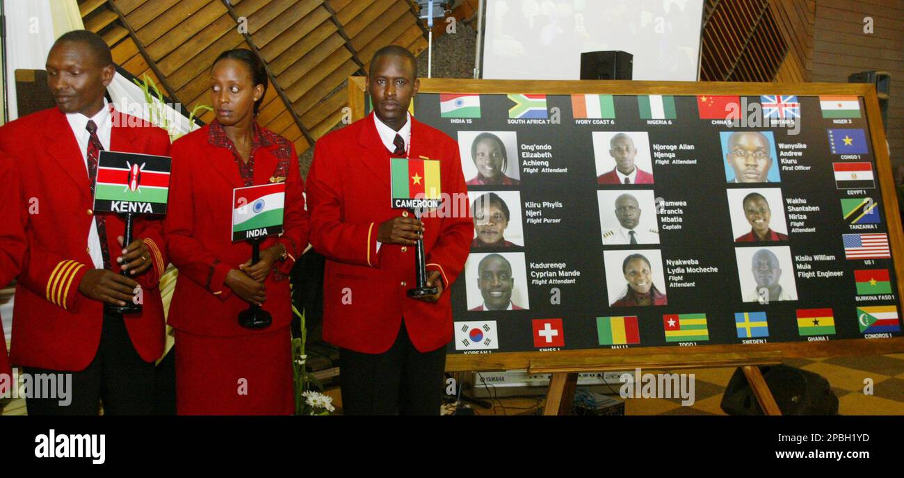 Kenya Airways staff hold the flags of different nationalities, Monday ...