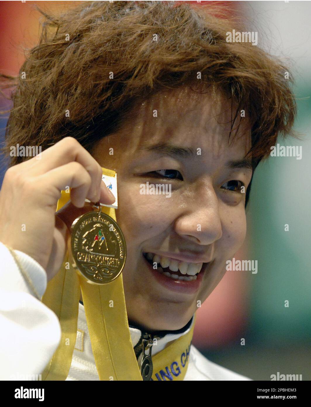 Japan's Kyoko Hamaguchi shows her gold medal in the 72-kilogram women's ...