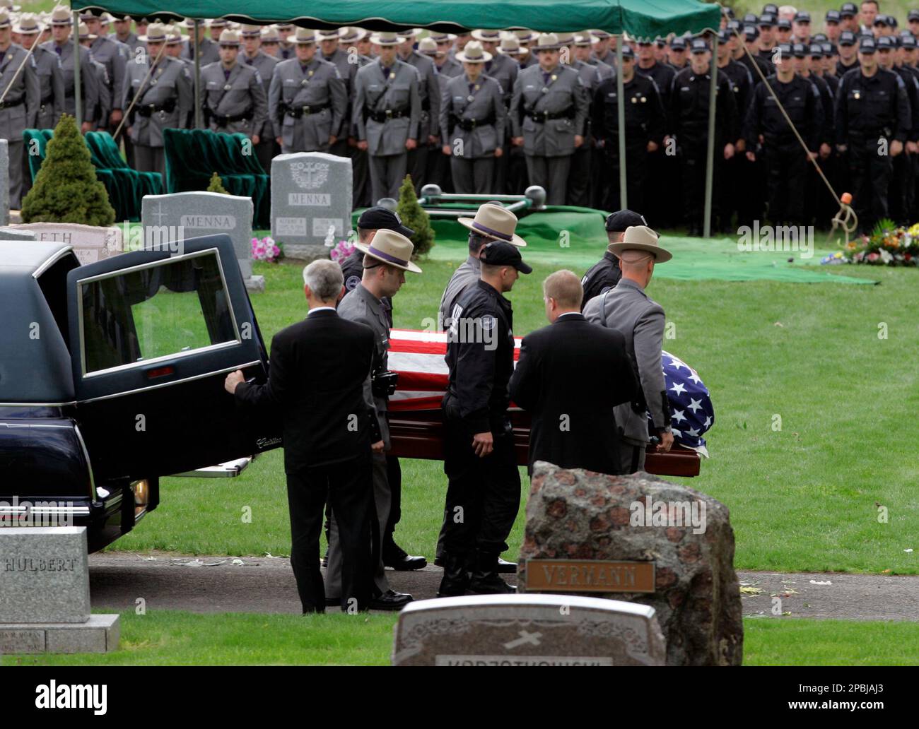 Pallbearers from the New York State Police carry the casket of slain ...