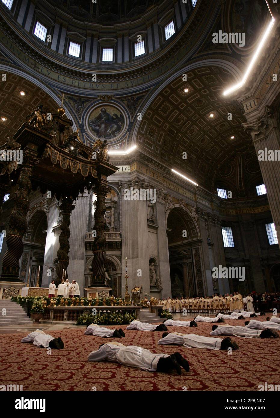 Men prostrate themselves on a carpet in front of the central altar as ...