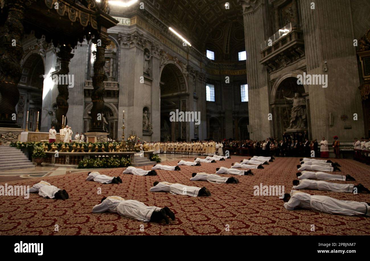 Men prostrate themselves on a carpet in front of the central altar as ...
