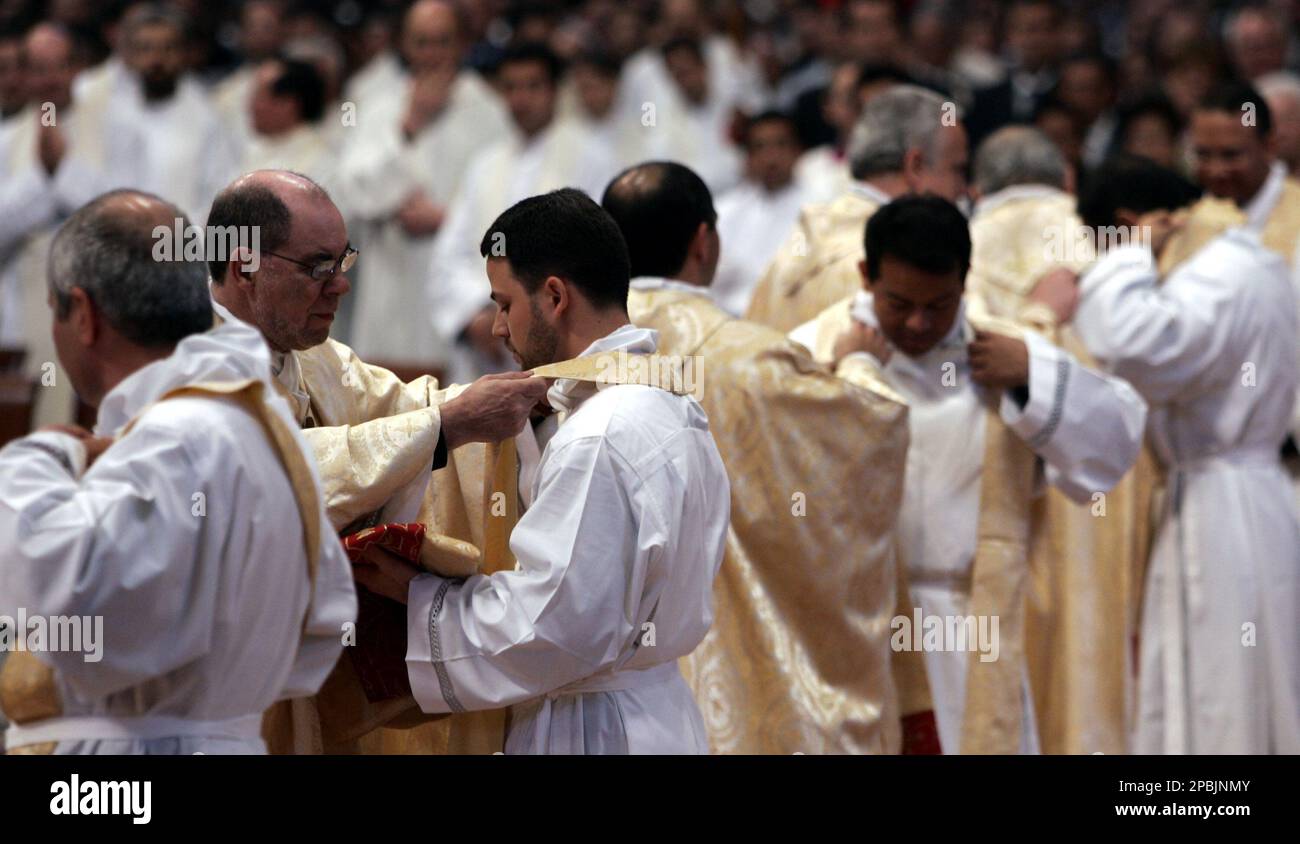 Newly ordained priests are helped by their mentors to wear their new ...