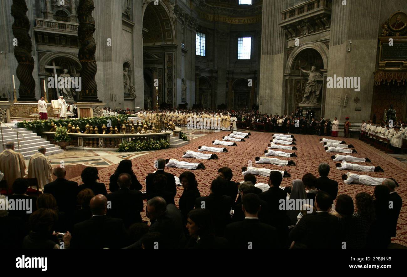 Men prostrate themselves on a carpet in front of the central altar as ...