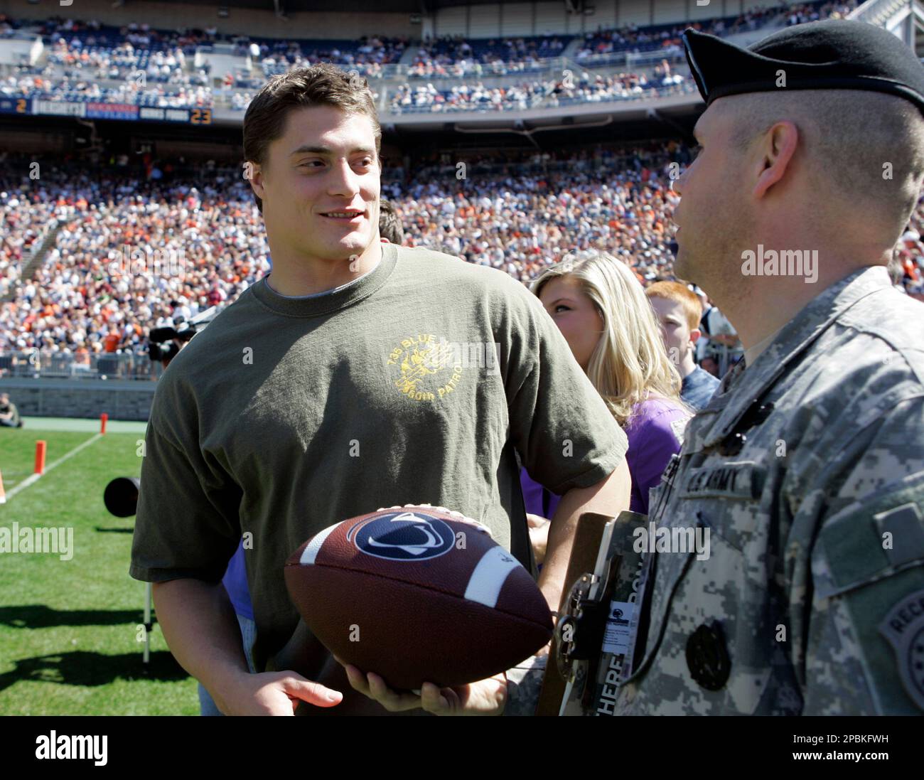 Former Penn State linebacker Paul Posluszny, left, autographs a ...