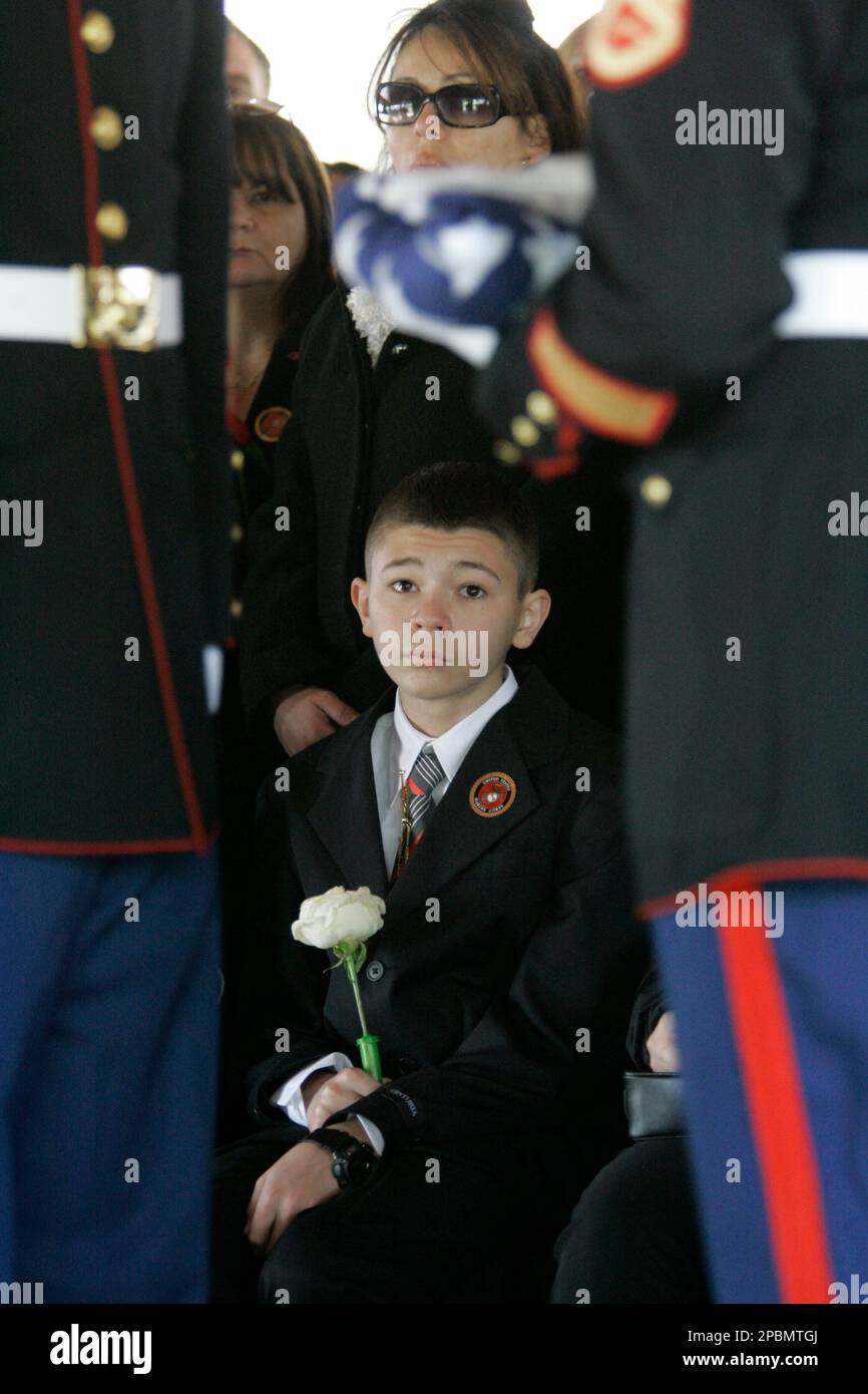 Pfc. Miguel A. Marcial III's brother Michael looks on as members of the ...