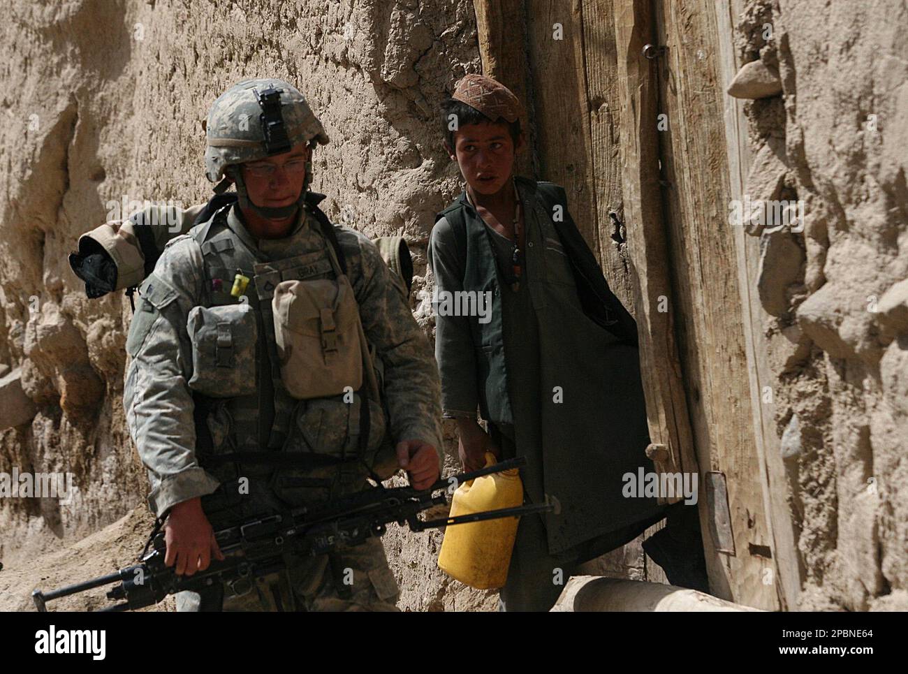 A U.S. soldier of B Company, 4th Infantry Regiment patrols as an afghan ...