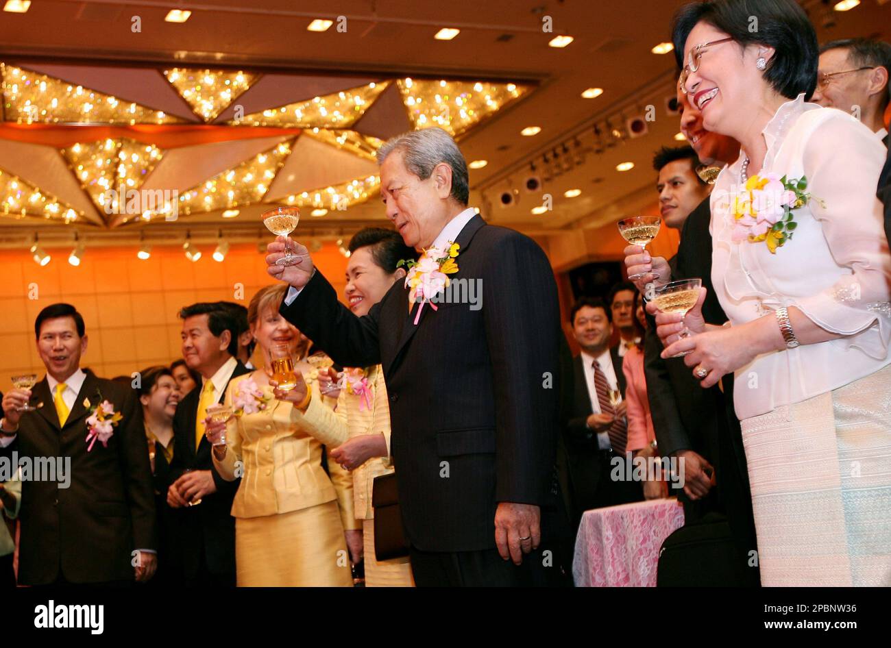 Thai Prime Minister Surayud Chulanont, center, accompanied by his wife ...