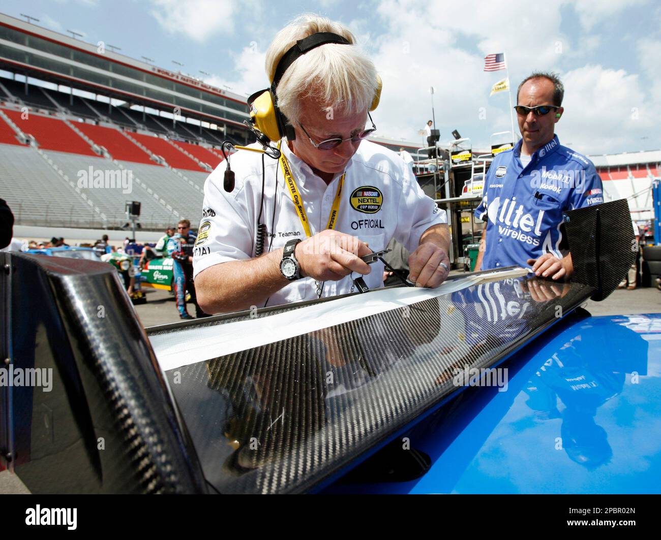 NASCAR official Mike Teaman, left, inspects the rear wing of the car ...