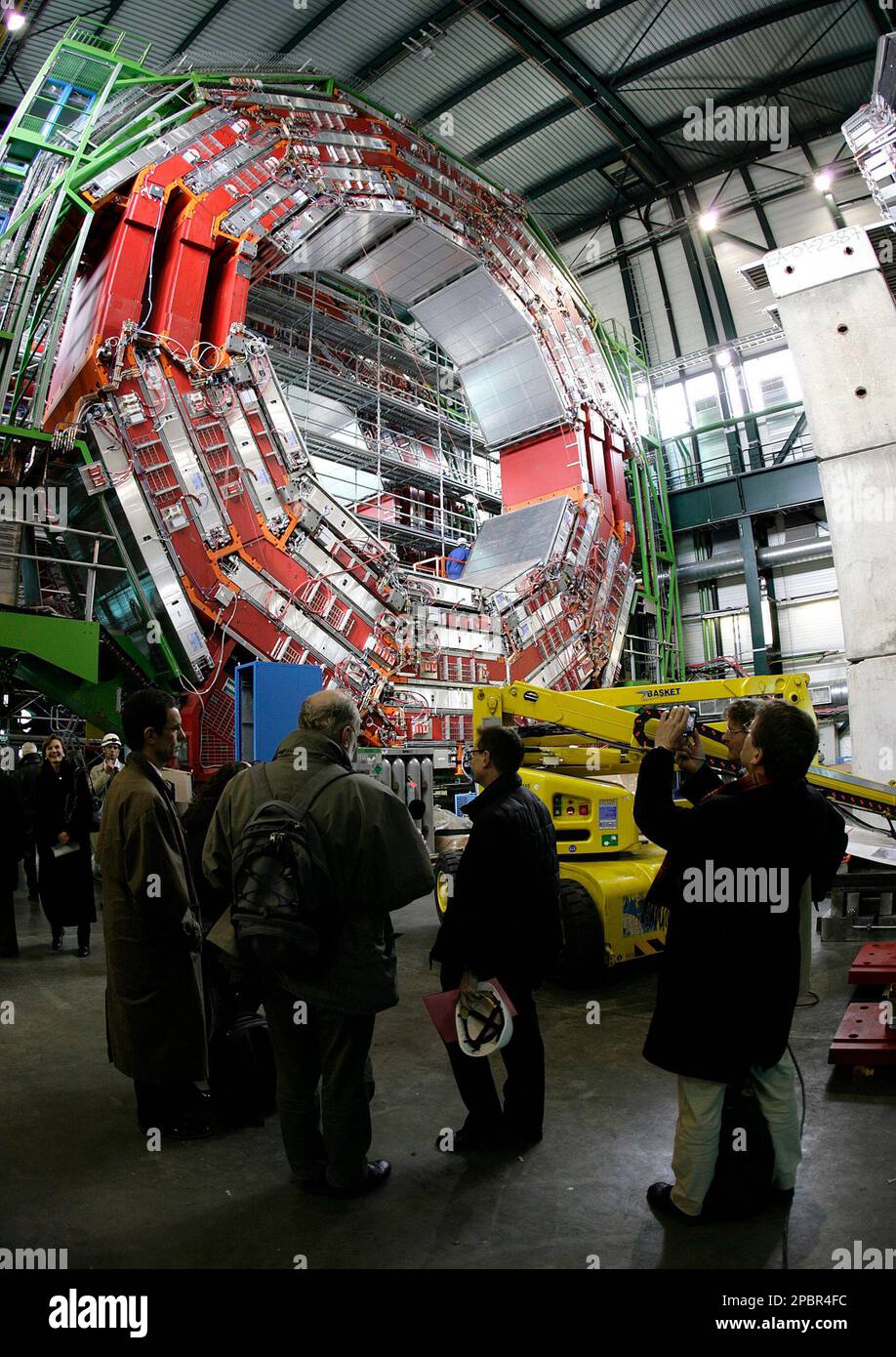 Spectators look at the giant magnet core of the world's largest ...