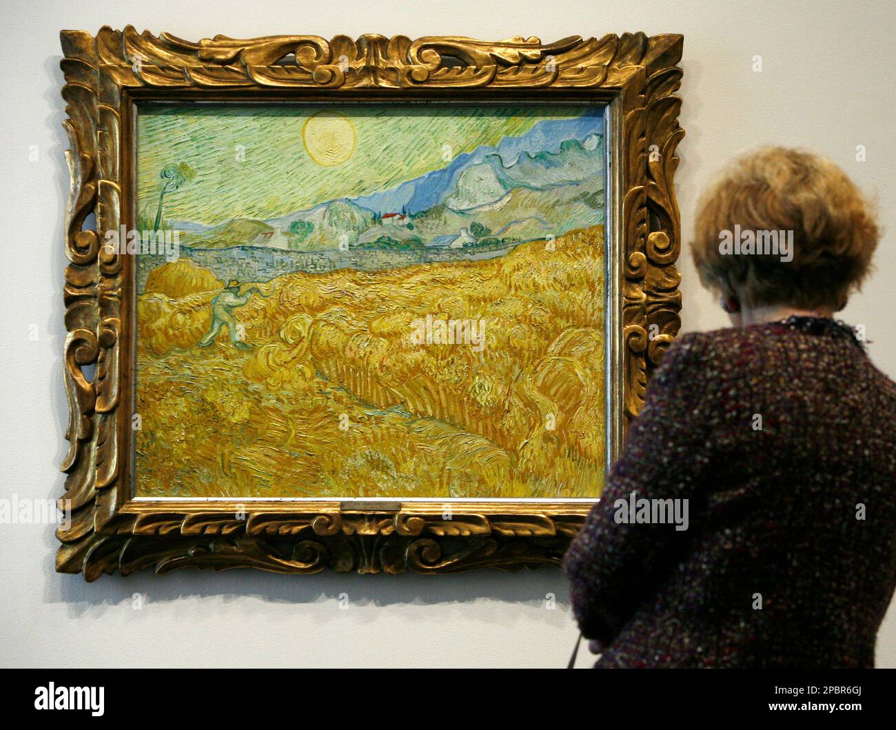 A woman views Vincent Van Gogh's "The Wheat Field Behind St. Paul's ...