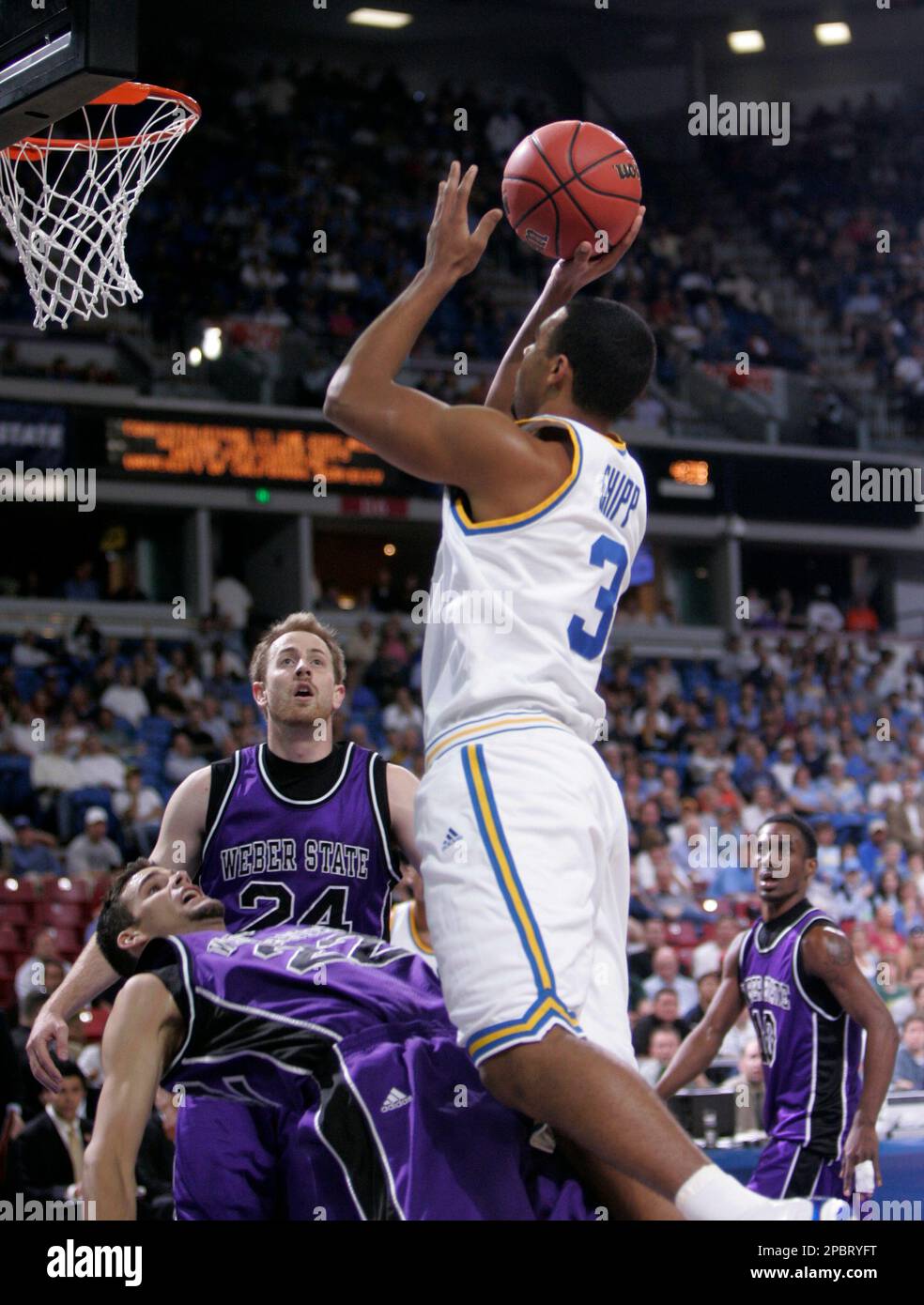 UCLA guard Josh Shipp, top, goes to the basket as Weber State forward ...