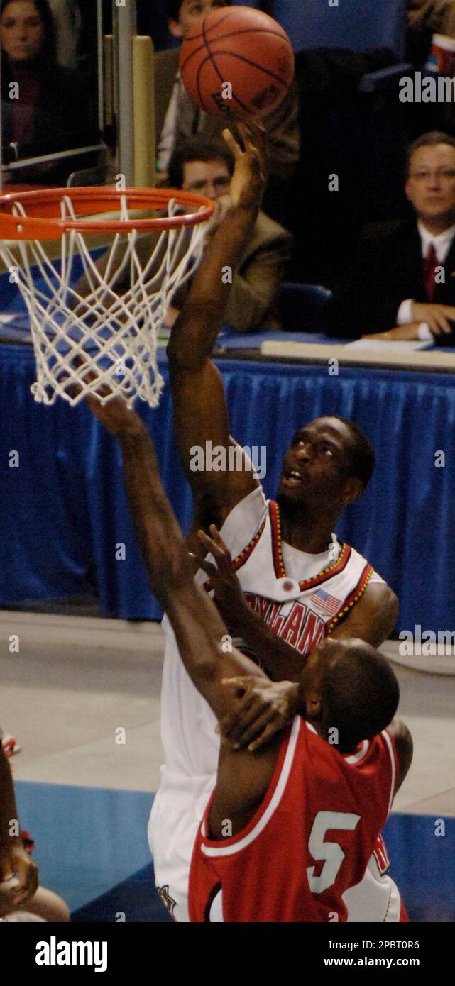 Maryland's James Gist shoots over Davidson's Boris Meno (5) during the ...