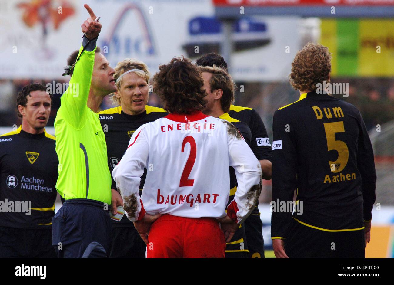 Surrounded by Aachen's players, referee Peter Gagelmann sends Aachens ...
