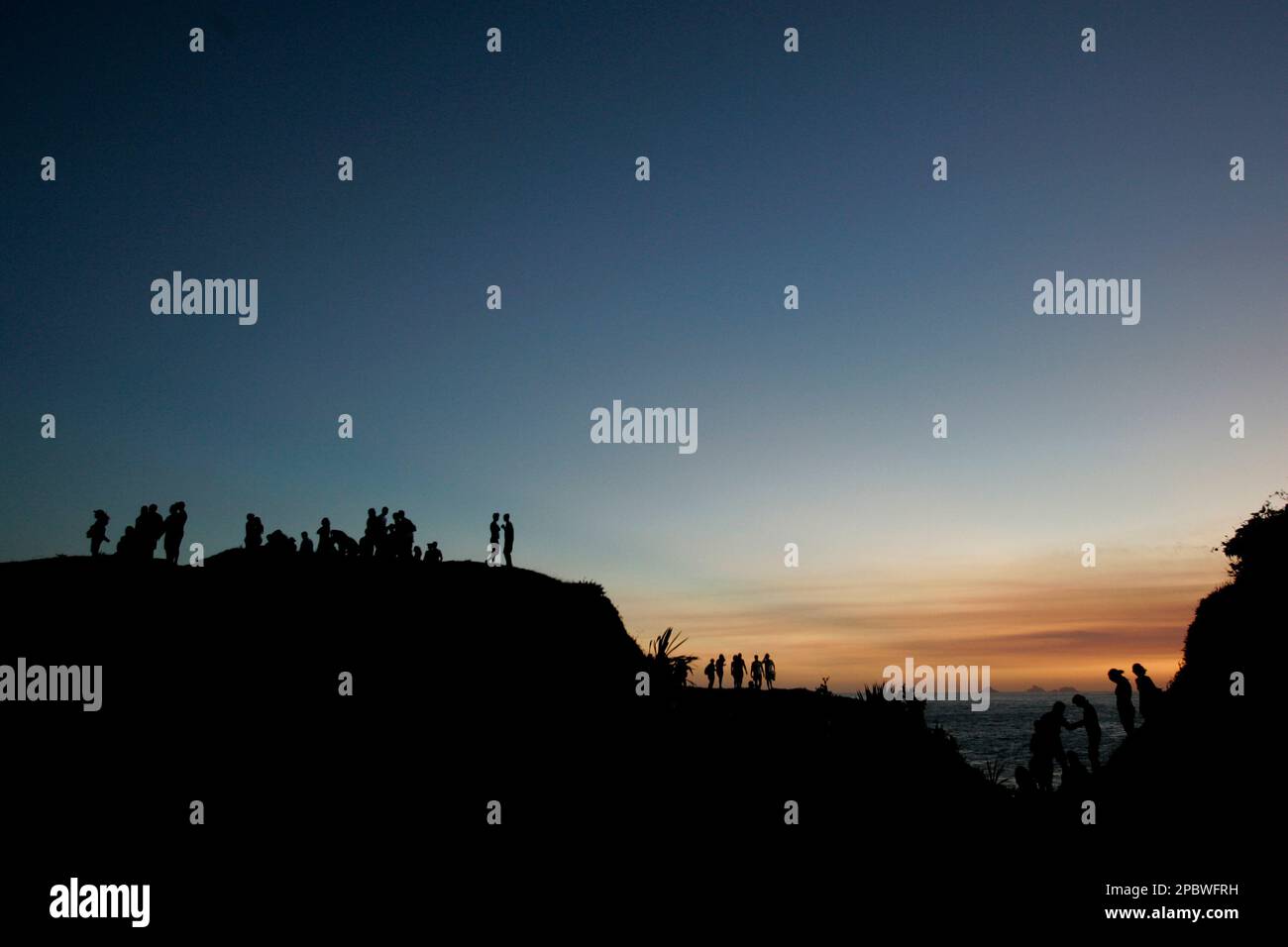 People gather to observe a lunar eclipse over Rio de Janeiro, Saturday ...