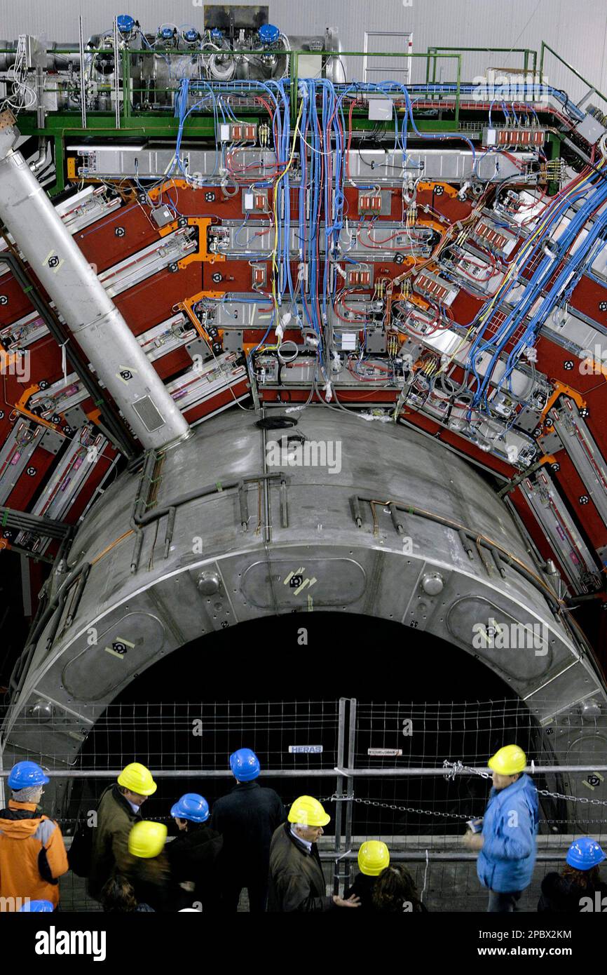 Spectators looks at the giant magnet Compact Muon Solenoid (CMS) being ...