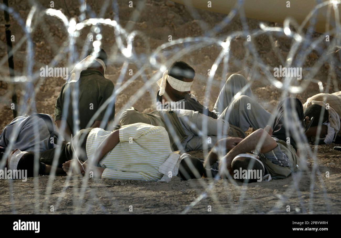 ** FILE ** Blindfolded and handcuffed Palestinians are seen on the ...