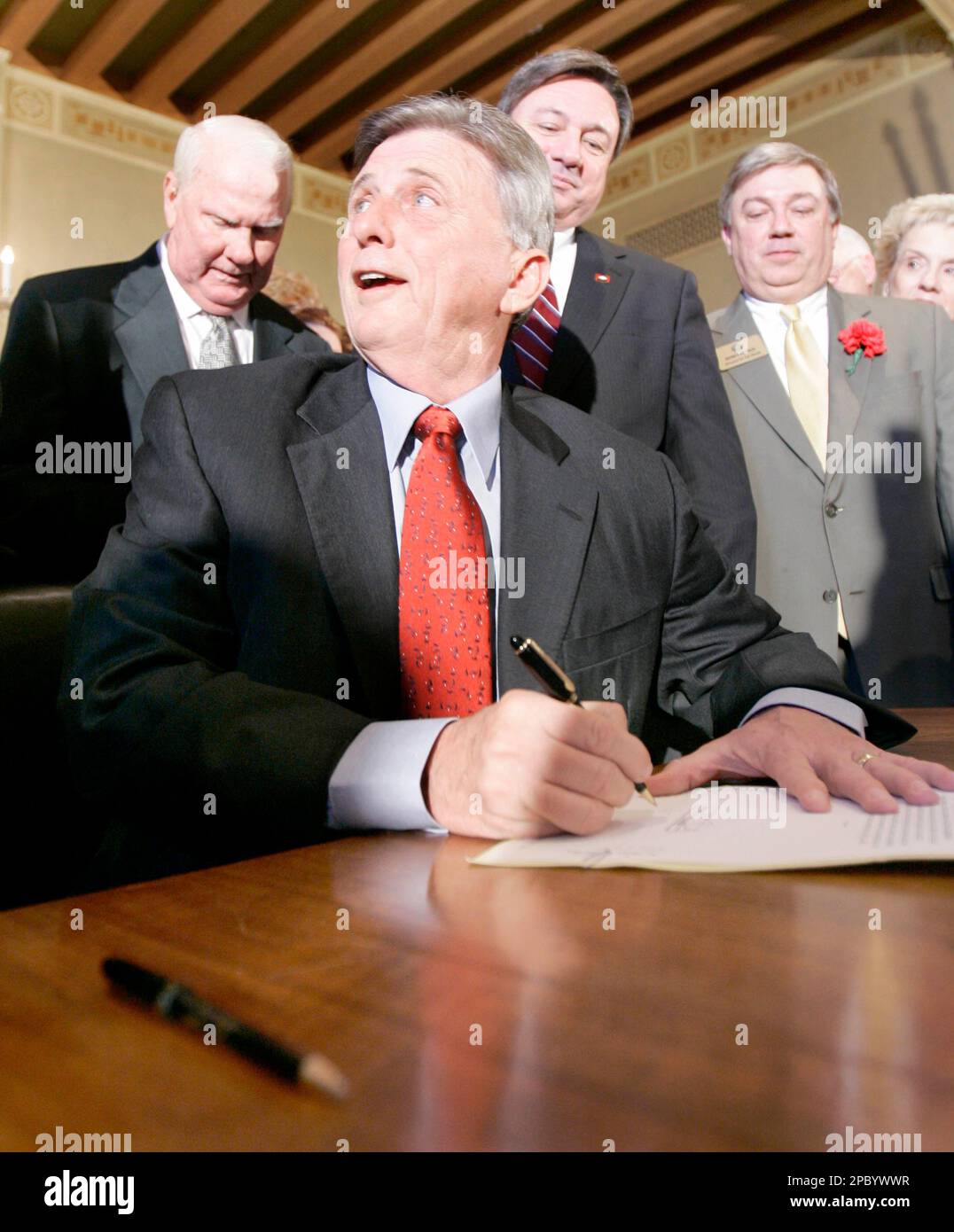 Arkansas Gov. Mike Beebe signs into law a 50 percent cut in the state ...