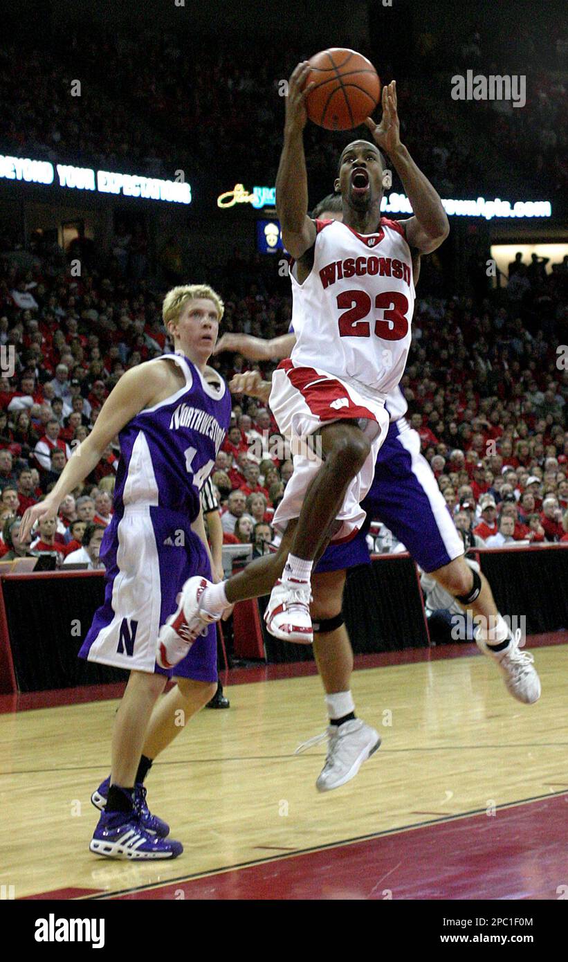 Wisconsin's Kammron Taylor (23) goes in for a layup past Northwestern's ...