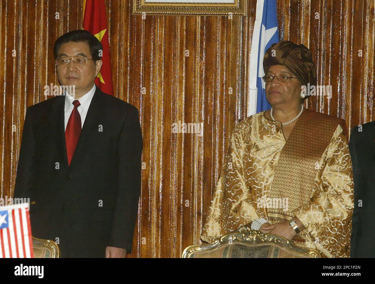 Chinese President Hu Jintao stands with Liberian leader Ellen Johnson ...