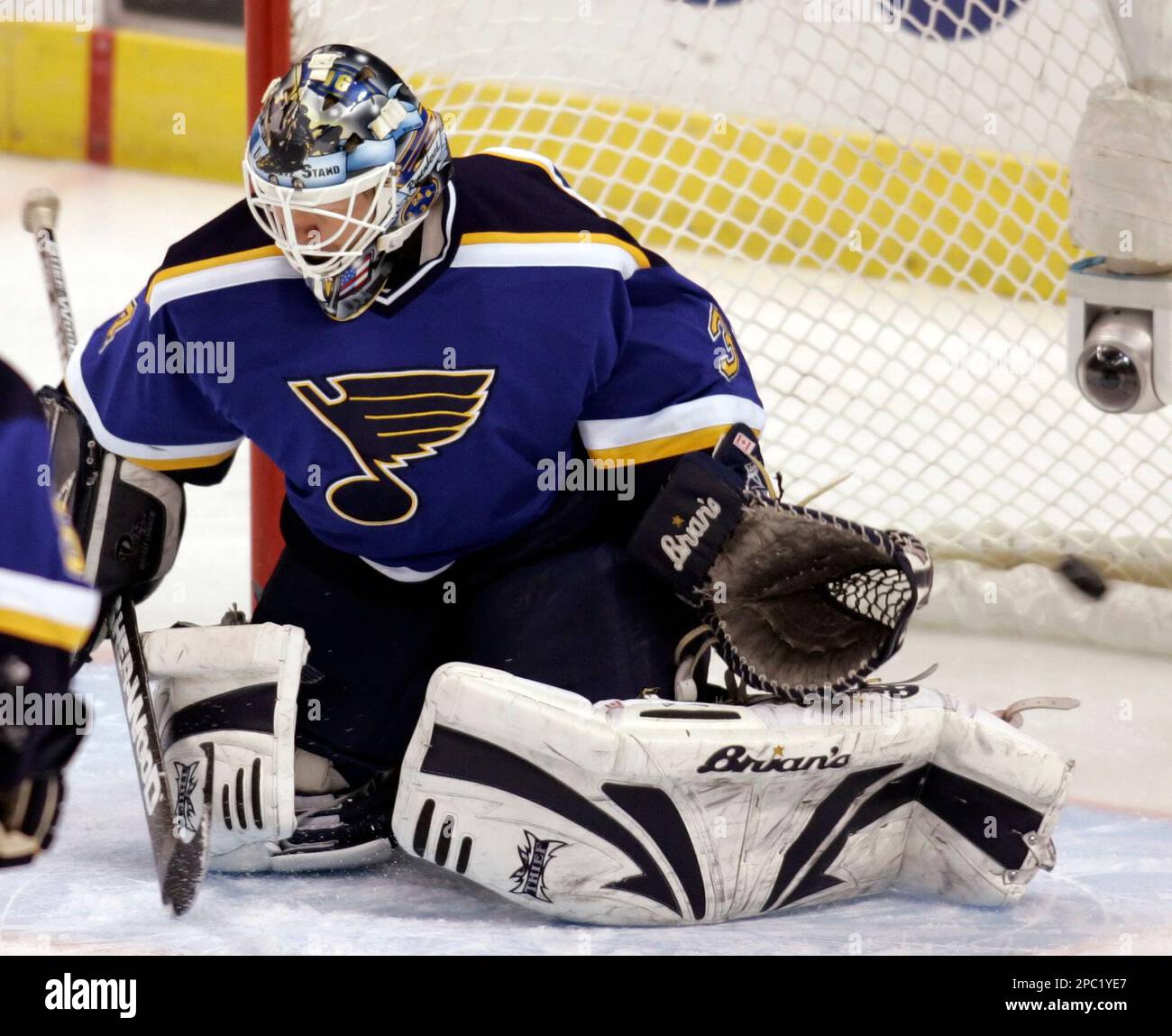 St. Louis Blues goaltender Manny Legace lets a shot by Minnesota Wild's ...