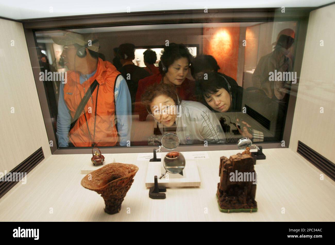 Visitors view miniature cultural artifacts from mainland China in new ...