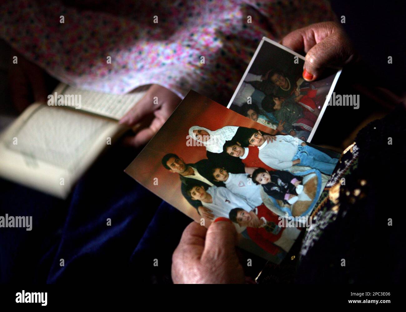 A Palestinian relative holds family pictures as Salwa Aramin, the ...