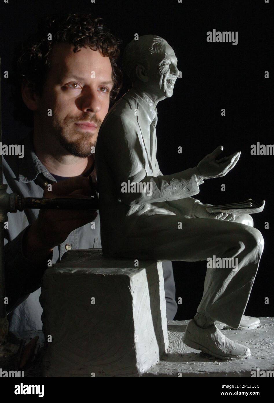 Sculptor Jamie Lester works on an 18-inch-tall clay model of the late ...
