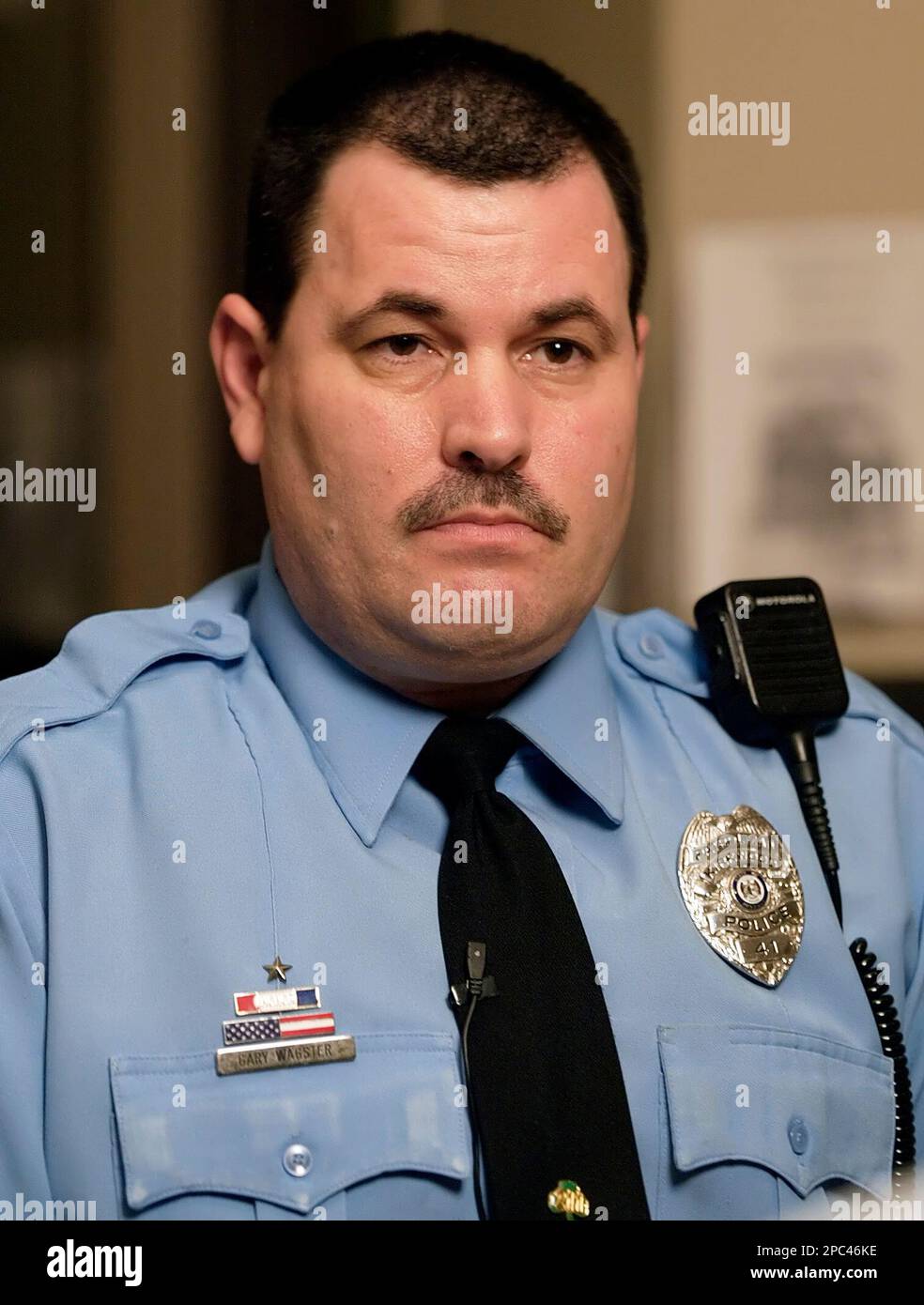 Officer Gary Wagster, of the Kirkwood police department, listens to a ...