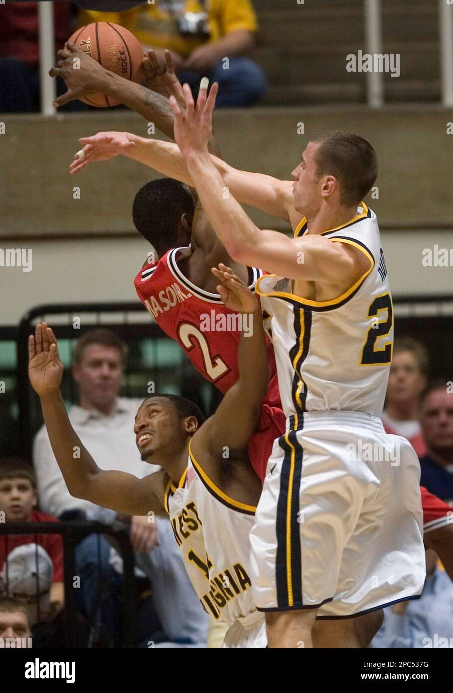 West Virginia's Darris Nichols, left, and Alex Ruoff, right, battle St ...