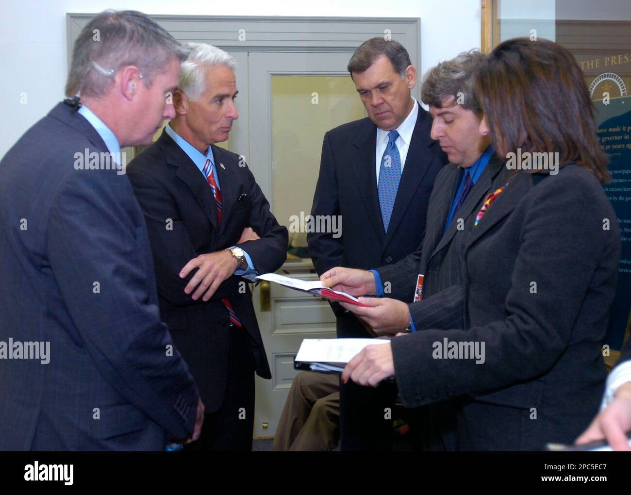 Florida Gov.-elect Charlie Crist, second from left, goes over final ...