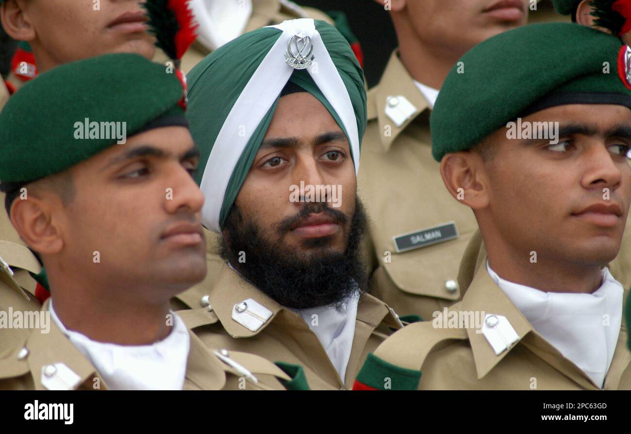 Harcharn Singh, center, first Sikh cadet of Pakistan Army, stands with ...