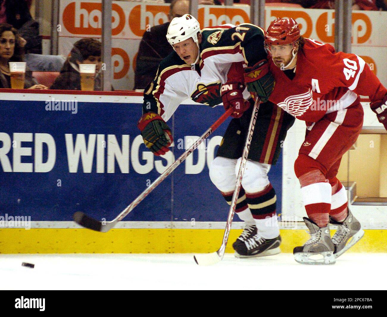 Minnesota Wild's Mark Parrish (21) loses the fight for this puck ...