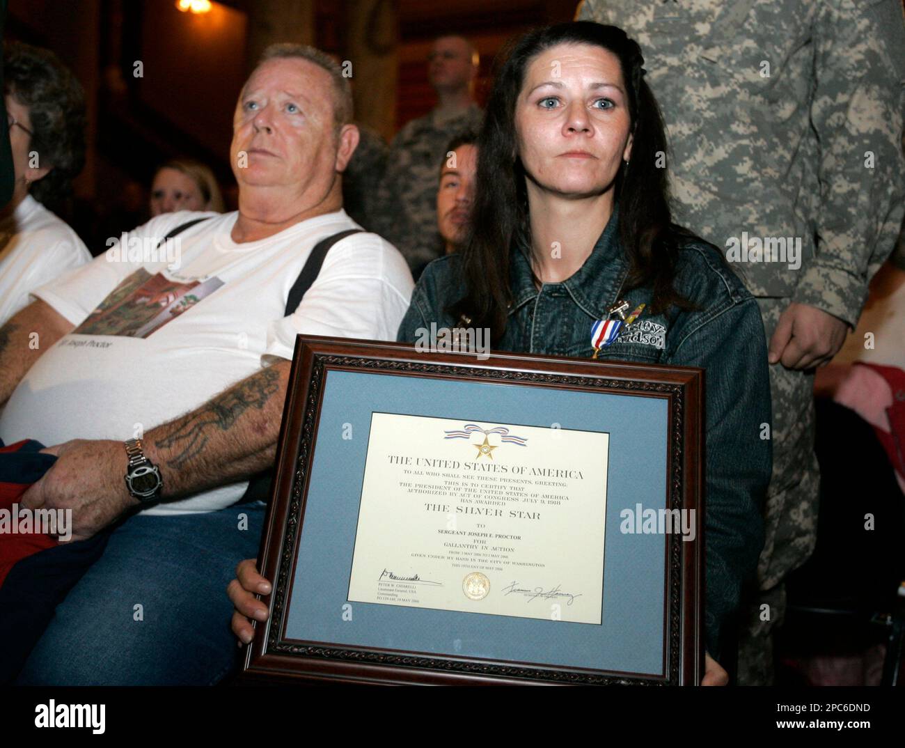 Beth Proctor displays a Silver Star medal certificate, awarded ...