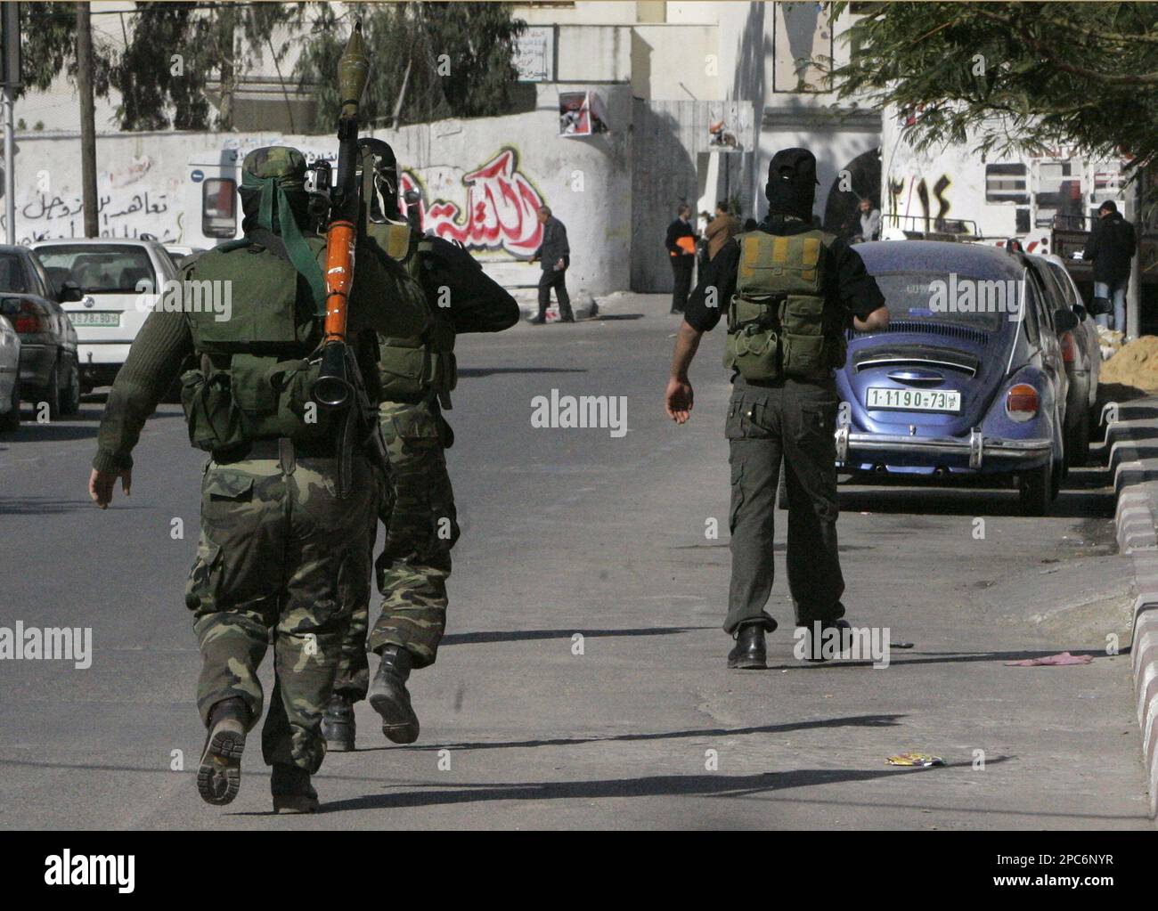 Hamas militants run into position in Gaza City, Sunday, Dec. 17, 2006 ...