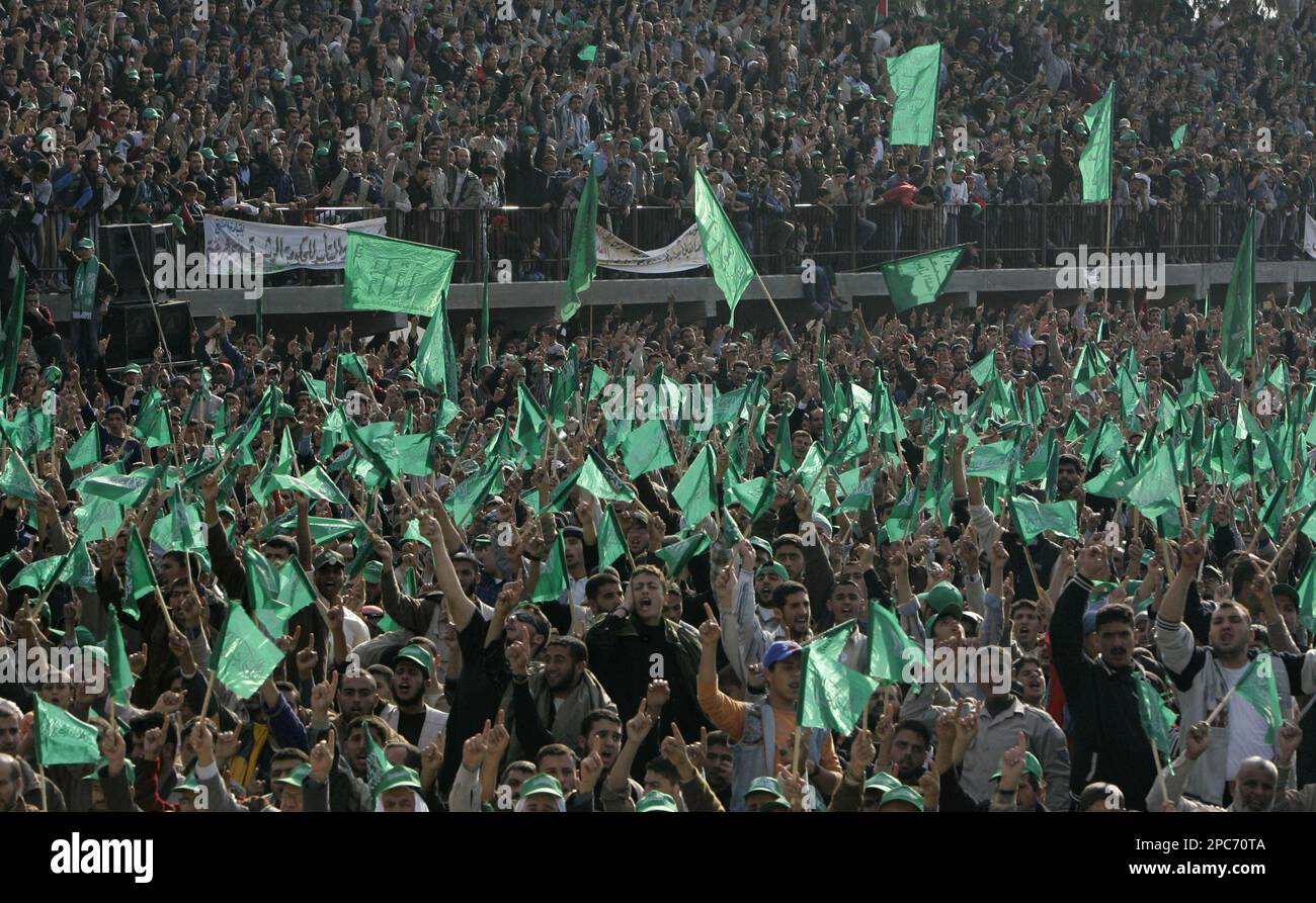 Hamas supporters wave flags as they gather for a speech by Palestinian ...