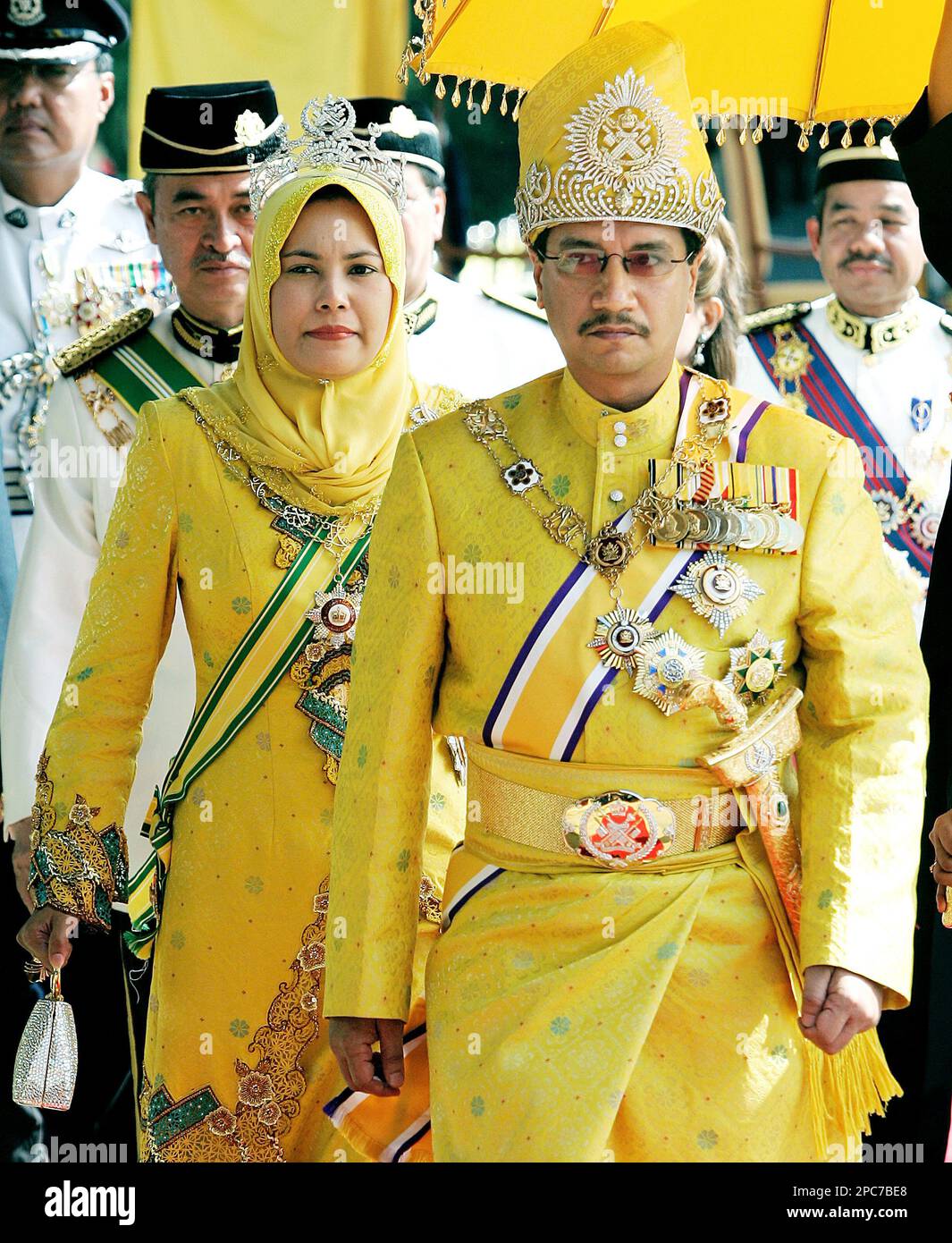 Malaysia's new King Sultan Mizan Zainal Abidin, right, is followed by ...