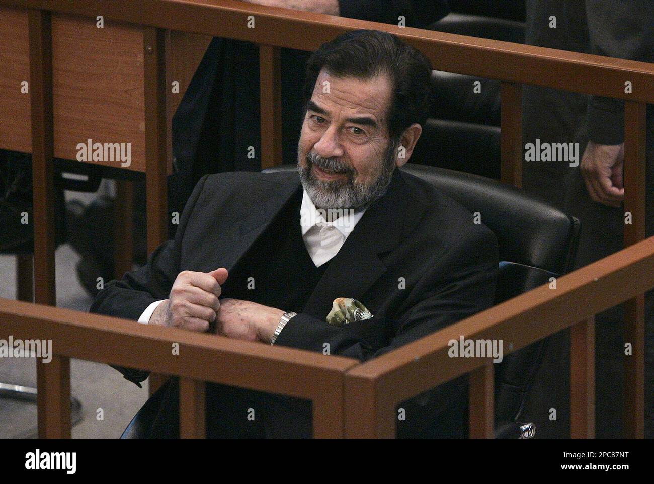 Deposed Iraqi leader Saddam Hussein smiles during his trial Wednesday ...