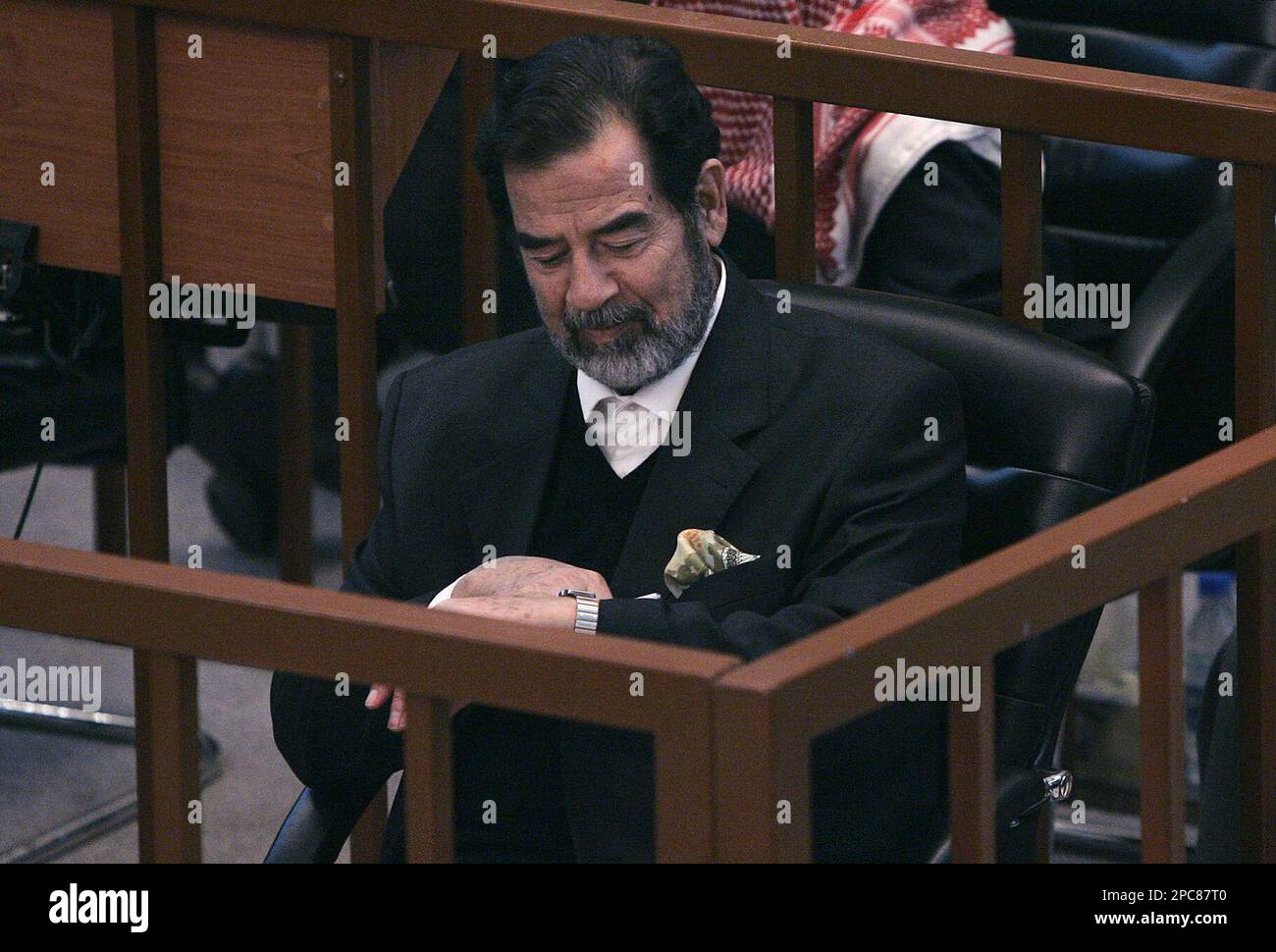 Deposed Iraqi leader Saddam Hussein checks his watch before lunch ...
