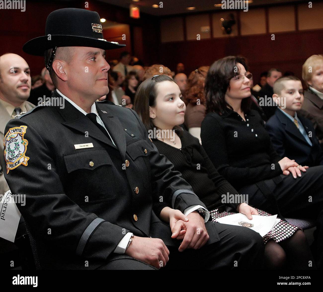 Teaghan Fallon, 10, second from left, holds her father Michael Fallon's ...