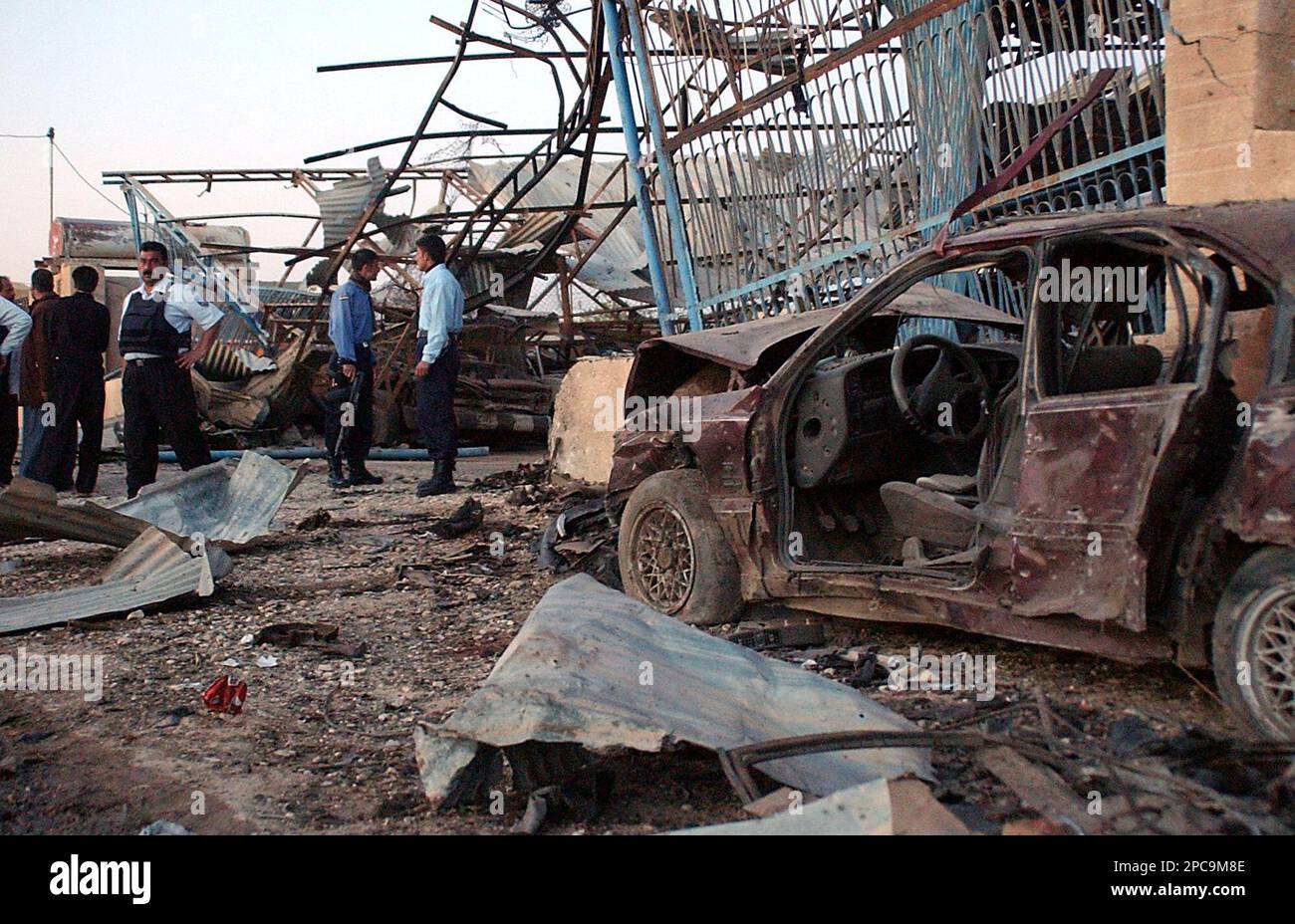 Iraqi police inspect the scene following an explosion in Tal Afar, Iraq ...