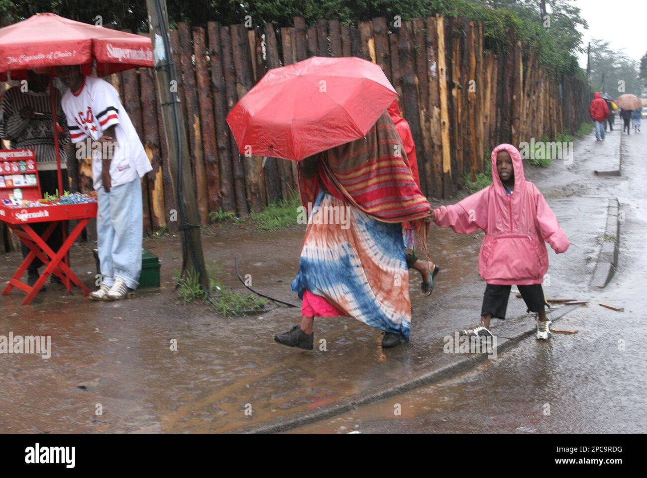 A Kenyan woman and her child walk in the rain, Thursday, Nov. 23, 2006 ...