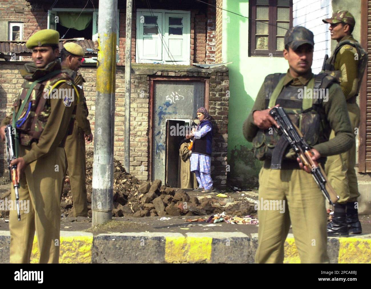 Indian paramilitary soldiers stand guard near the site of a grenade ...