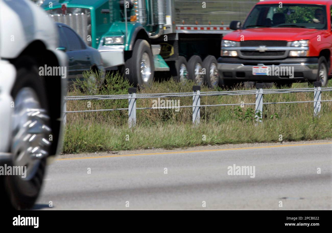 A steel-cable barrier runs between the north- and southbound lanes as ...