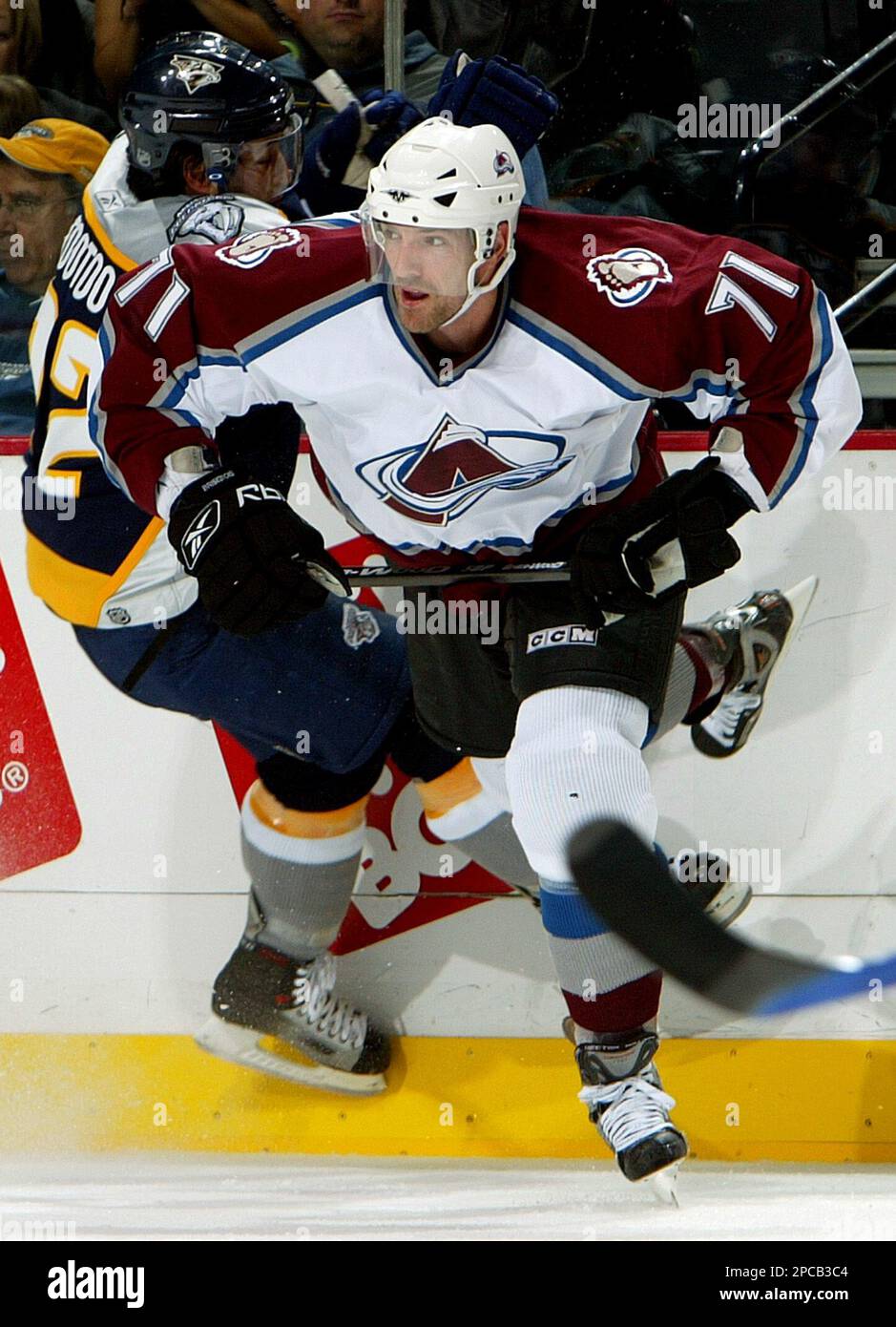 Colorado Avalanche defenseman Patrice Brisebois (71) avoids a check by ...